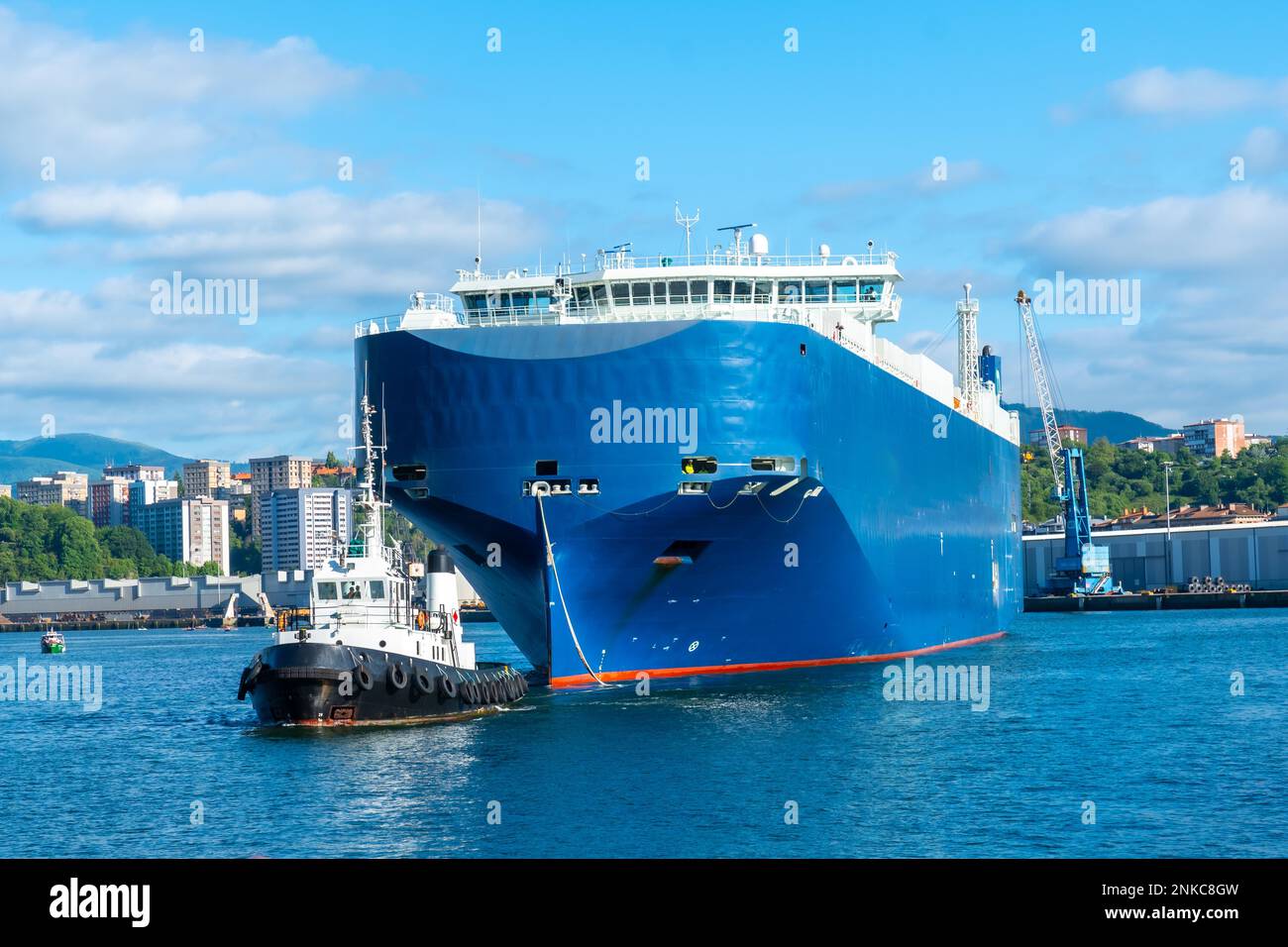 Cargo ship transporting a giant ship in the bay of Pasaia to the open ...