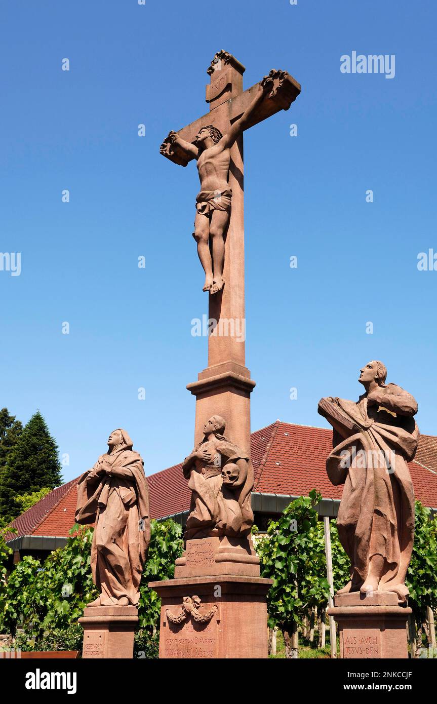 Christ cross with sculptures of saints against blue sky, Durbach, Baden ...