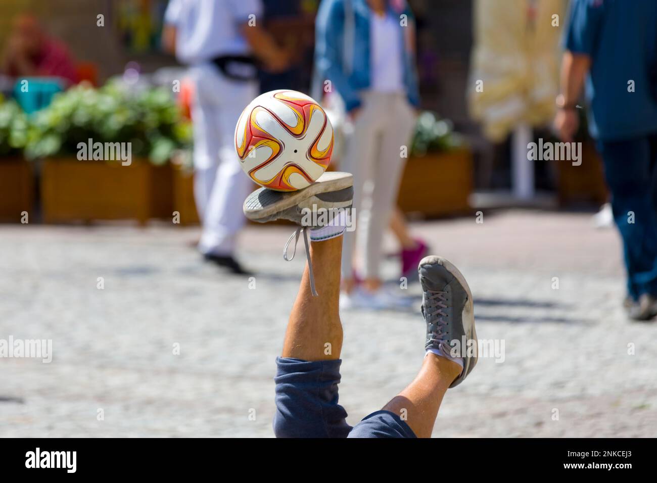 Street acrobat, juggling a ball on his head acrobat Stock Photo - Alamy