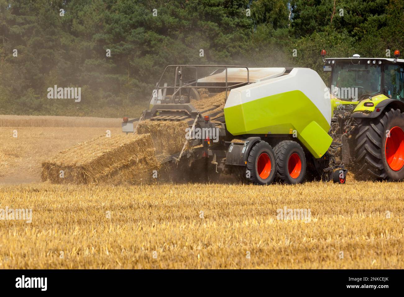 Tractor with a straw baler Stock Photo - Alamy