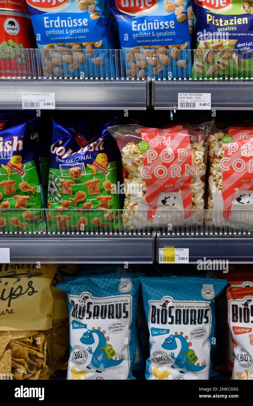 Sales shelf snack products peanuts, crisps and popcorn Stock Photo - Alamy