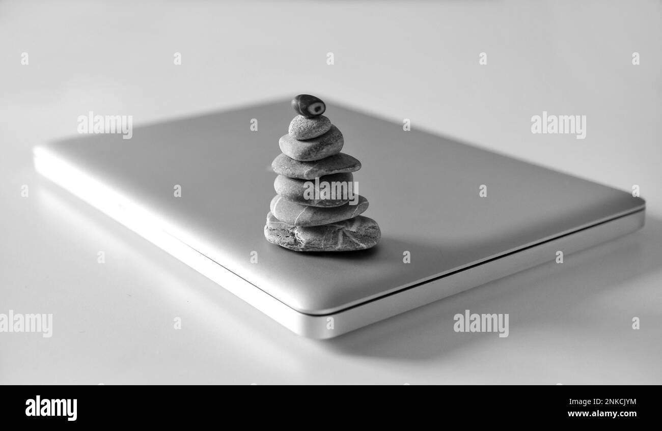 Closed laptop, stone pyramid Stock Photo - Alamy