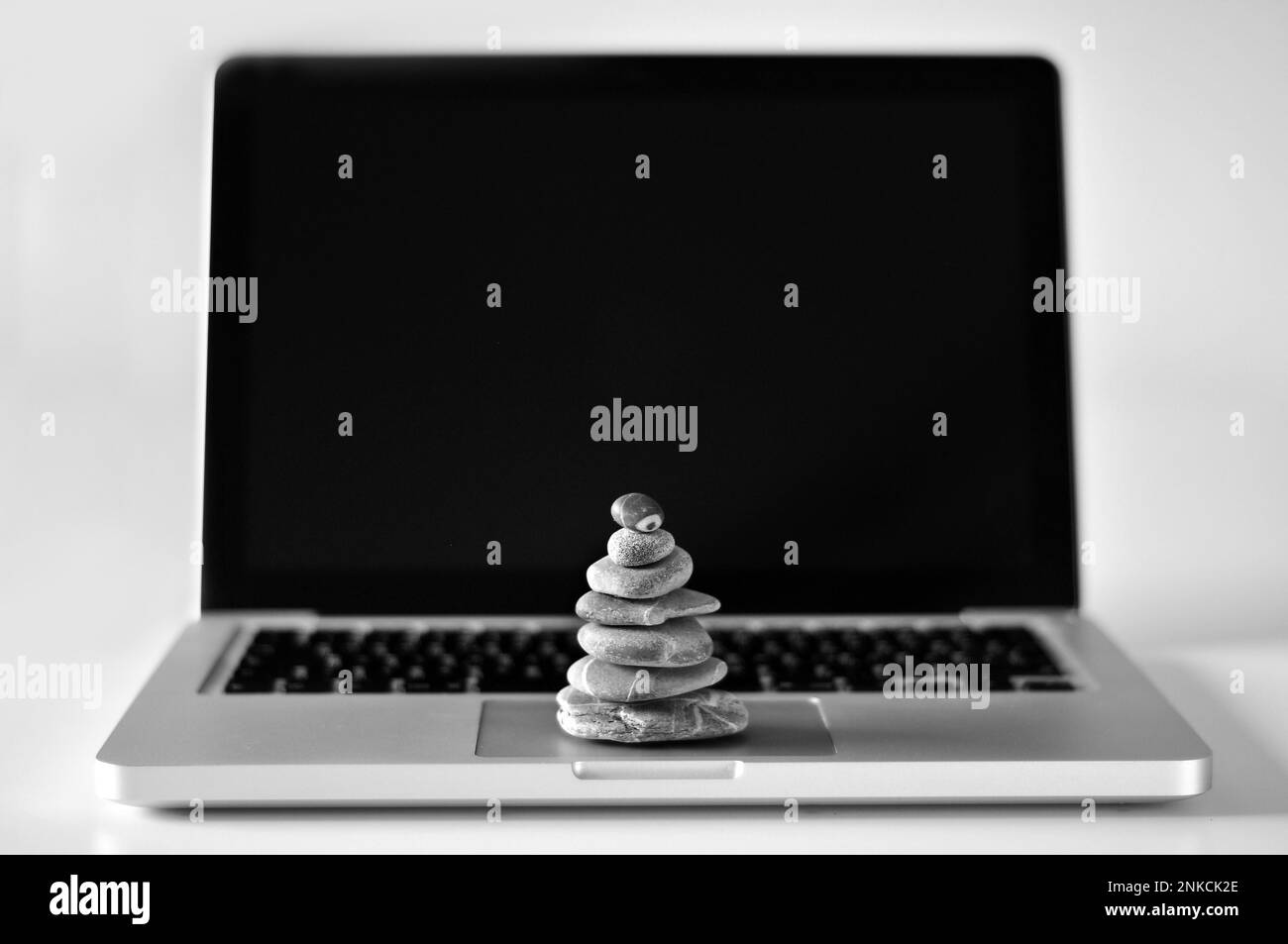Opened laptop, with stone pyramid on the touchpad Stock Photo - Alamy