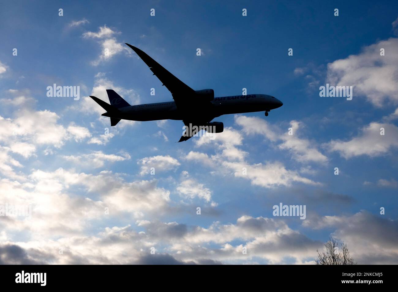 Commercial aircraft overflying the sky and arriving at airport Stock ...