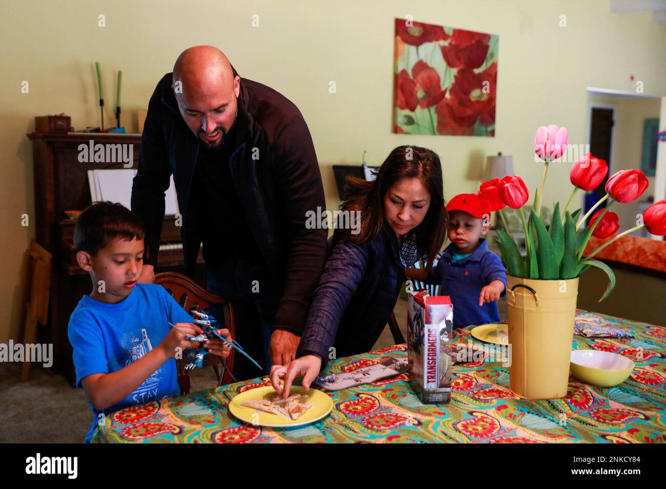 (l-r) Kalani Rivera, 6 shows off a toy to his father David Rivera as ...