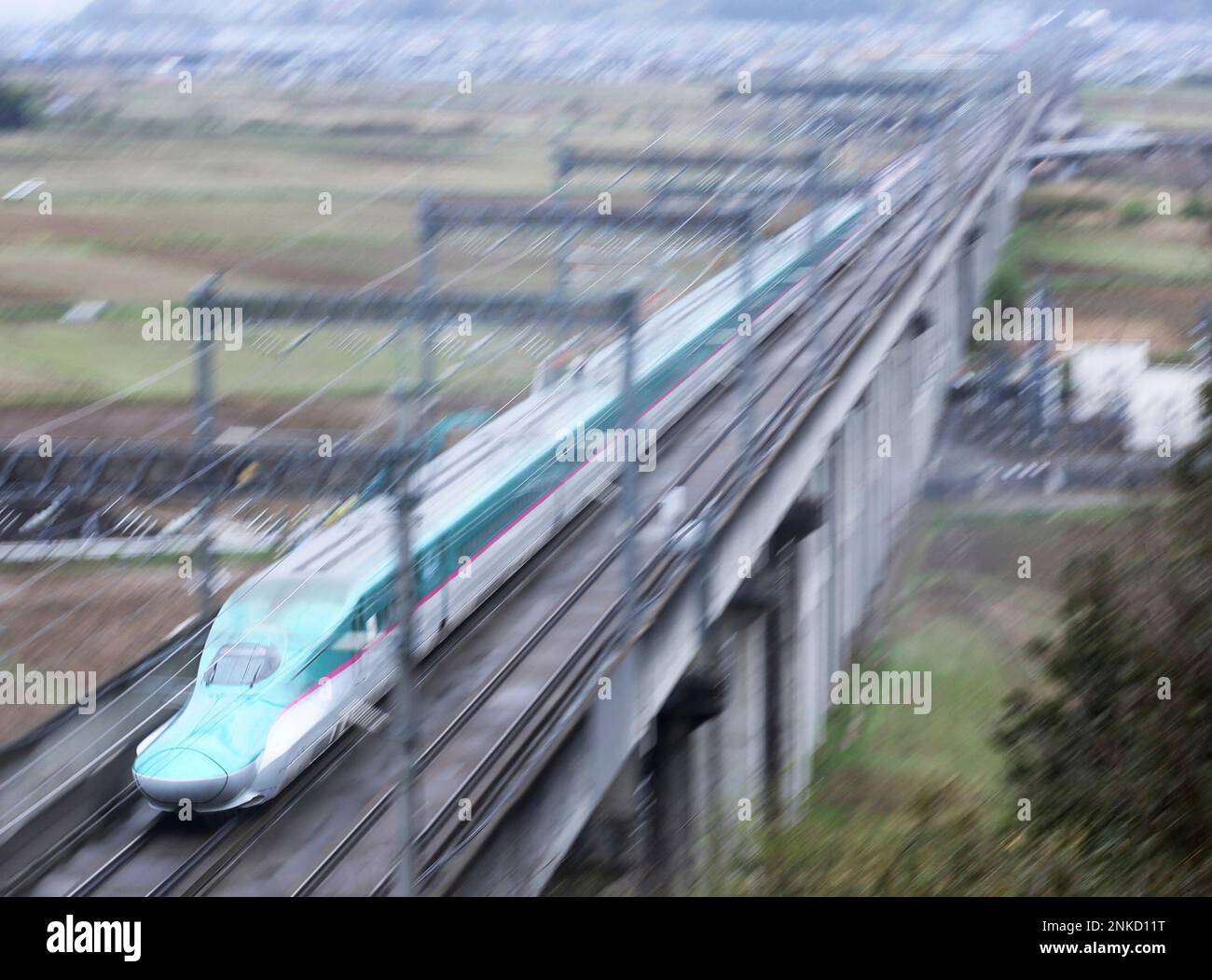 Tohoku Shinkansen bullet train passes an accident site that a train ...