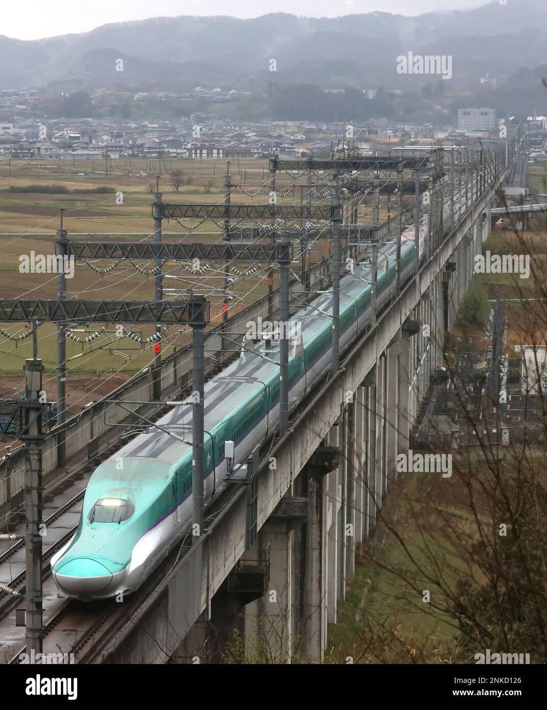 Tohoku Shinkansen bullet train passes an accident site that a train ...