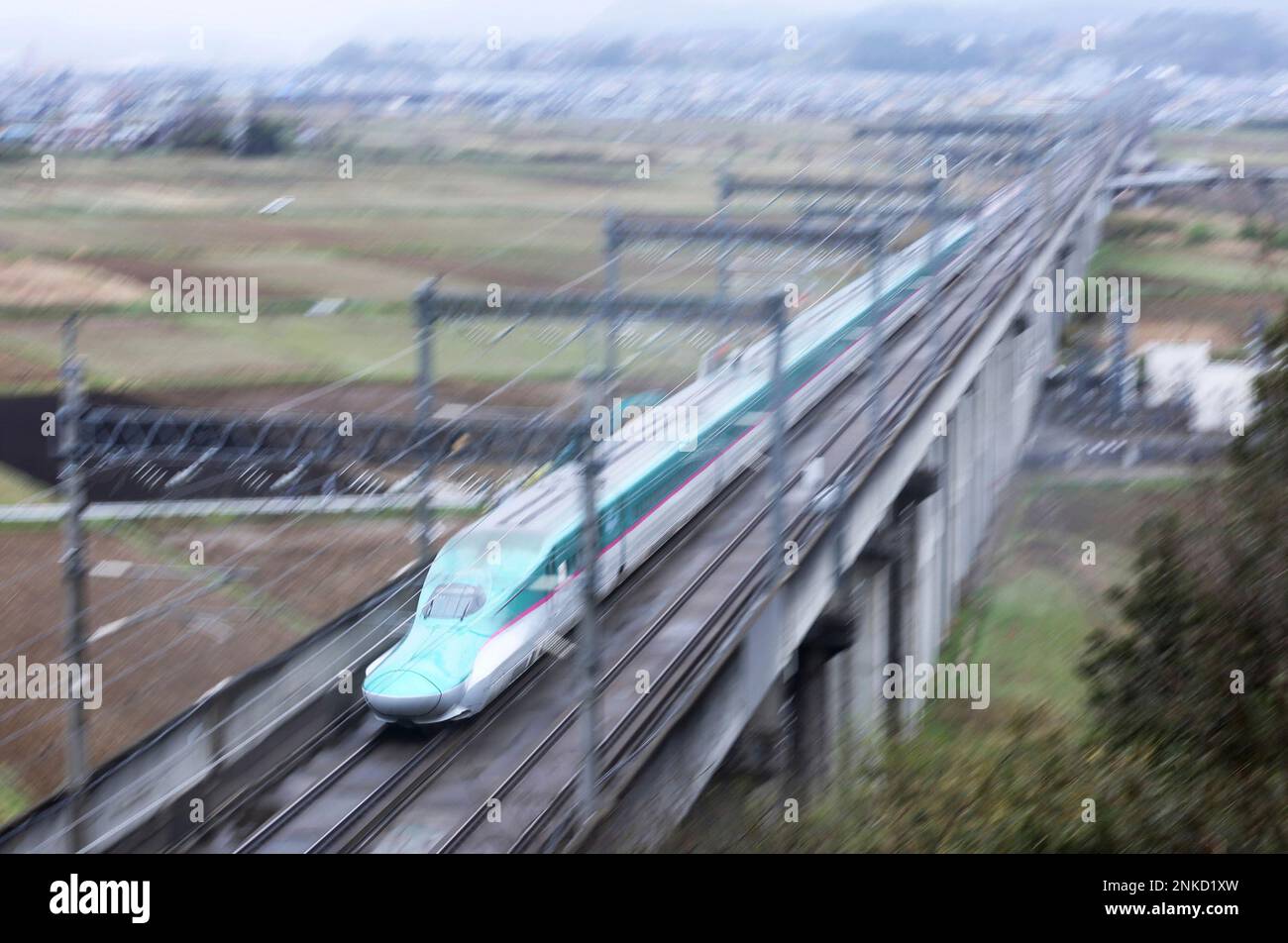 Tohoku Shinkansen bullet train passes an accident site that a train ...