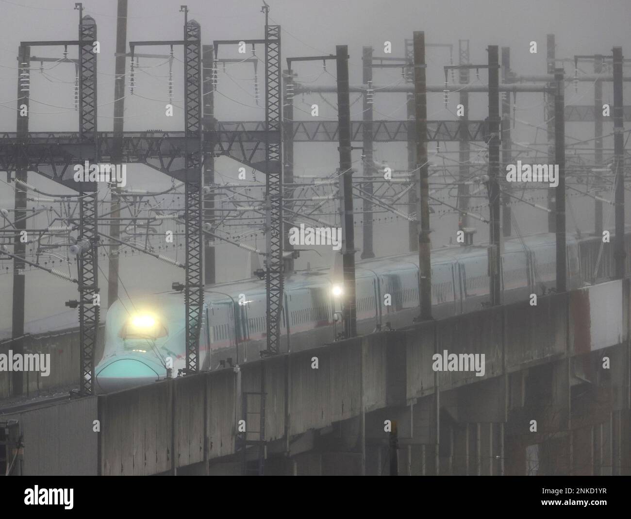 Tohoku Shinkansen bullet train passes an accident site that a train ...