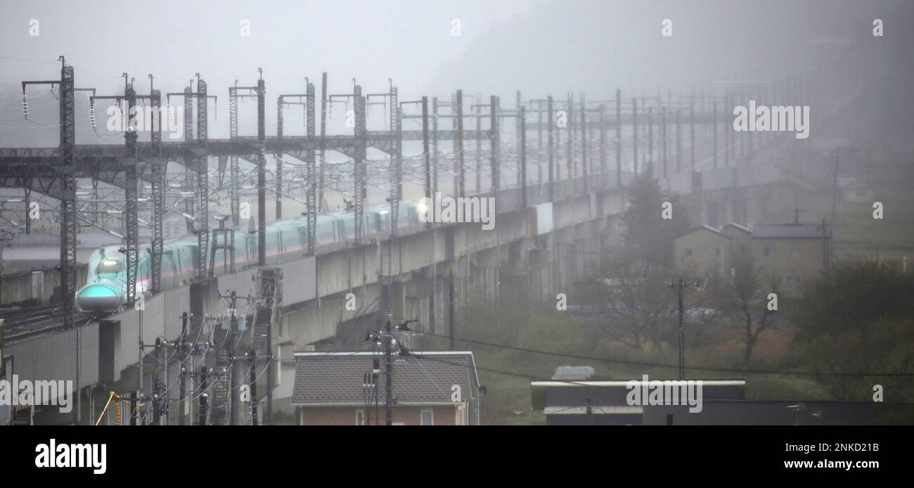 Tohoku Shinkansen bullet train passes an accident site that a train ...