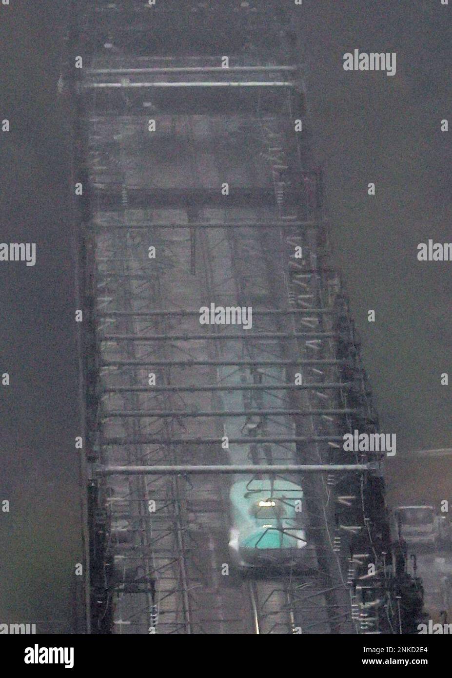 Tohoku Shinkansen bullet train passes an accident site that a train ...