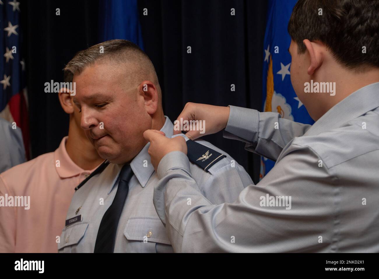 Col. Eric Stringer, the 152nd Medical Group commander, stands on stage ...
