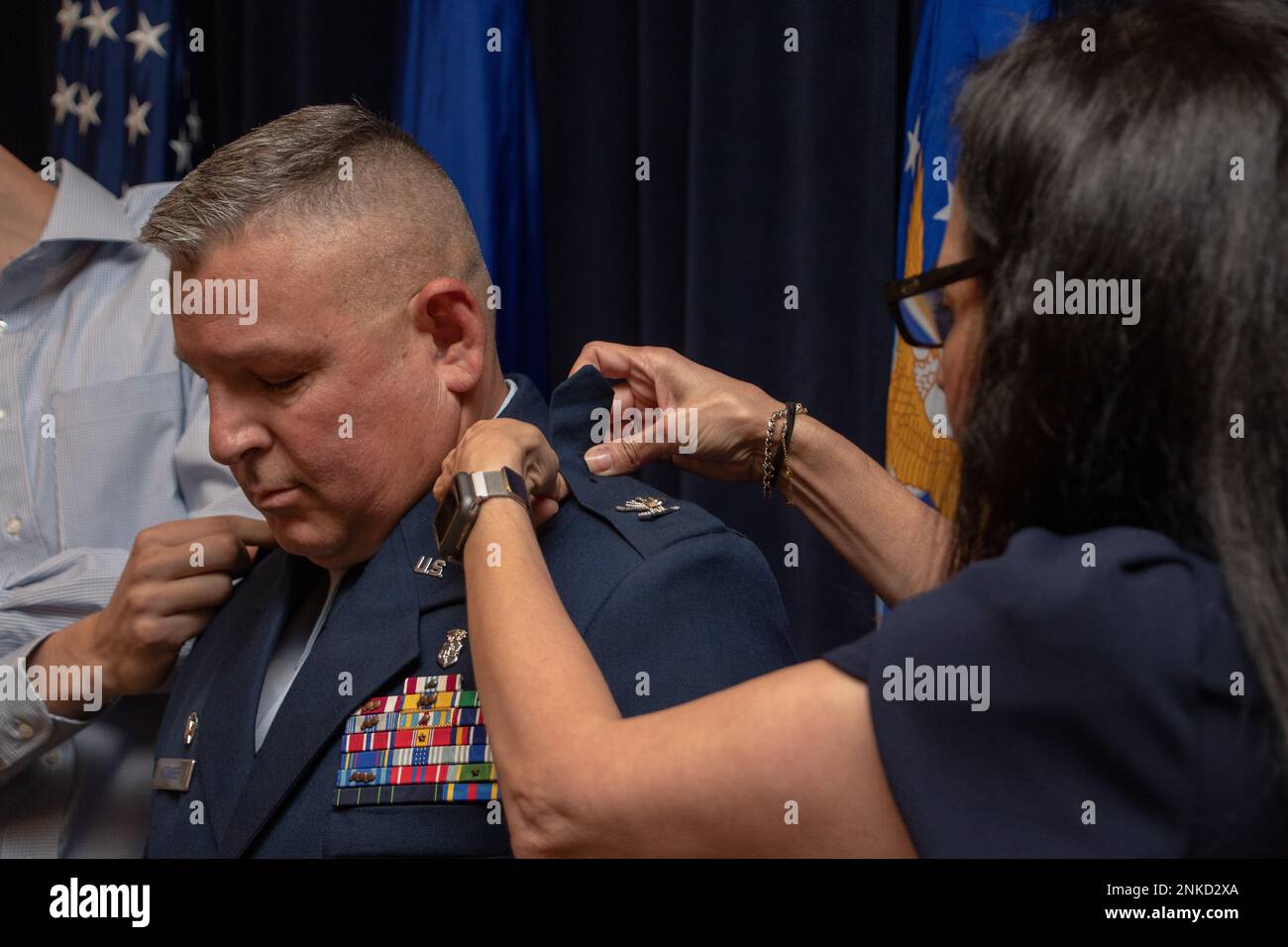 Col. Eric Stringer's wife and son pin his new rank onto his lapels ...