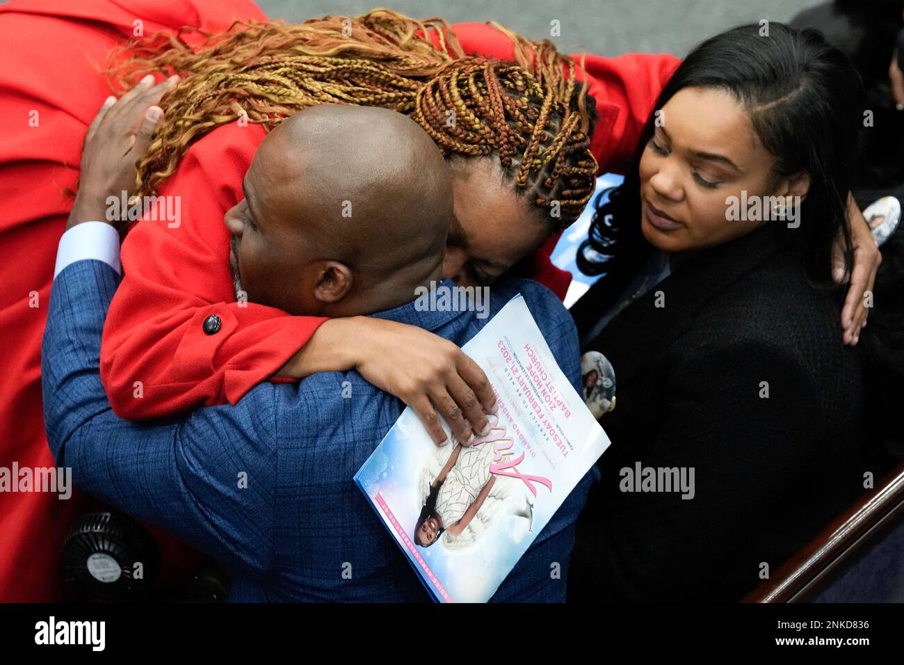 A mourner hugs Jerome Lloyd-Anderson and Dawana Davis, father and ...