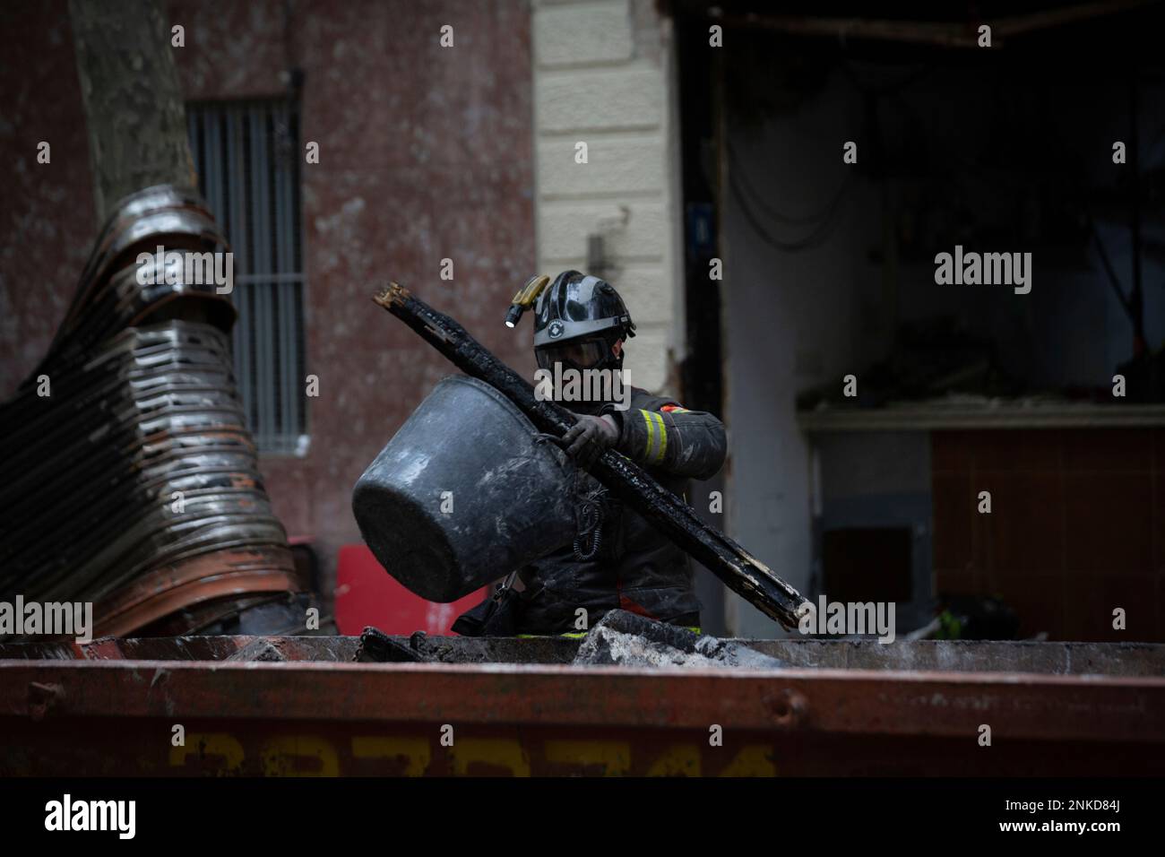 A firefighter works on building fires caused by a bar explosion in ...