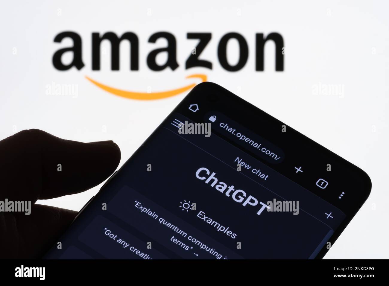 ChatGPT chat bot screen seen on smartphone and blurred AMAZON logo on the background.AI chatbot ...