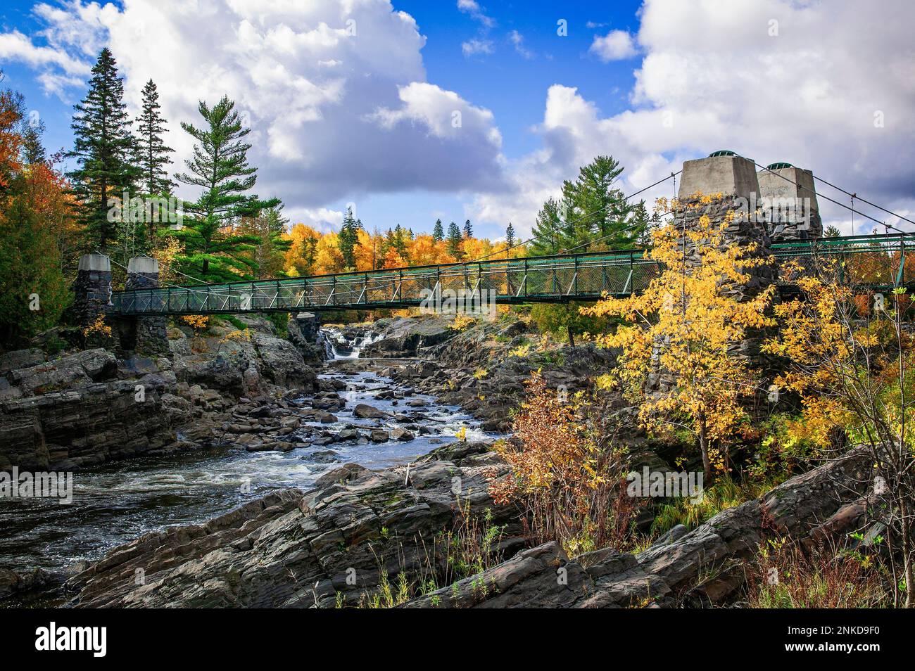 A suspension bridge crosses the Saint Louis River in Jay Cooke State ...