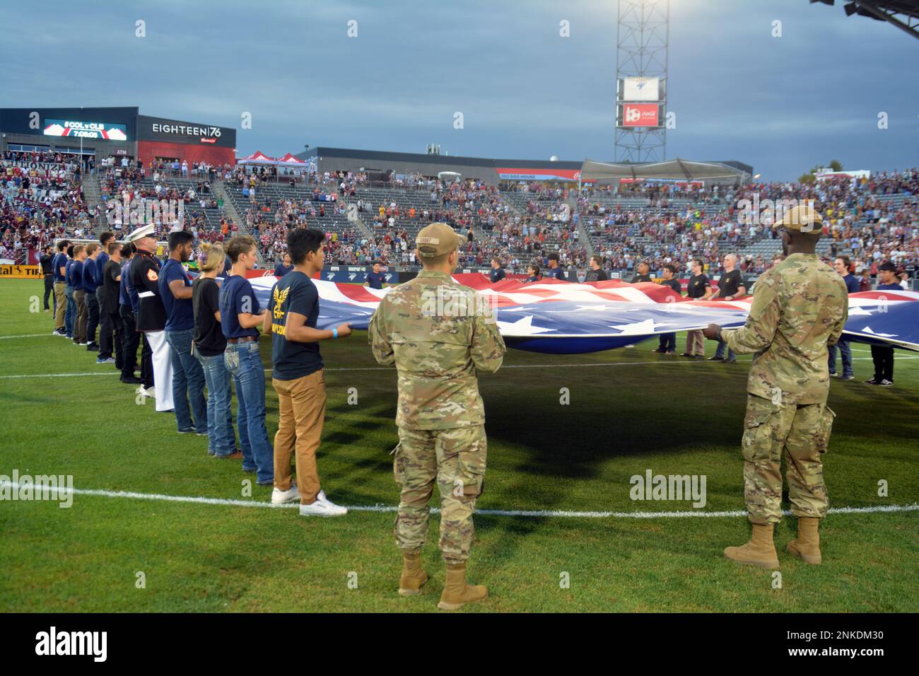 Military members and future service men/women hold the U.S. flag for ...