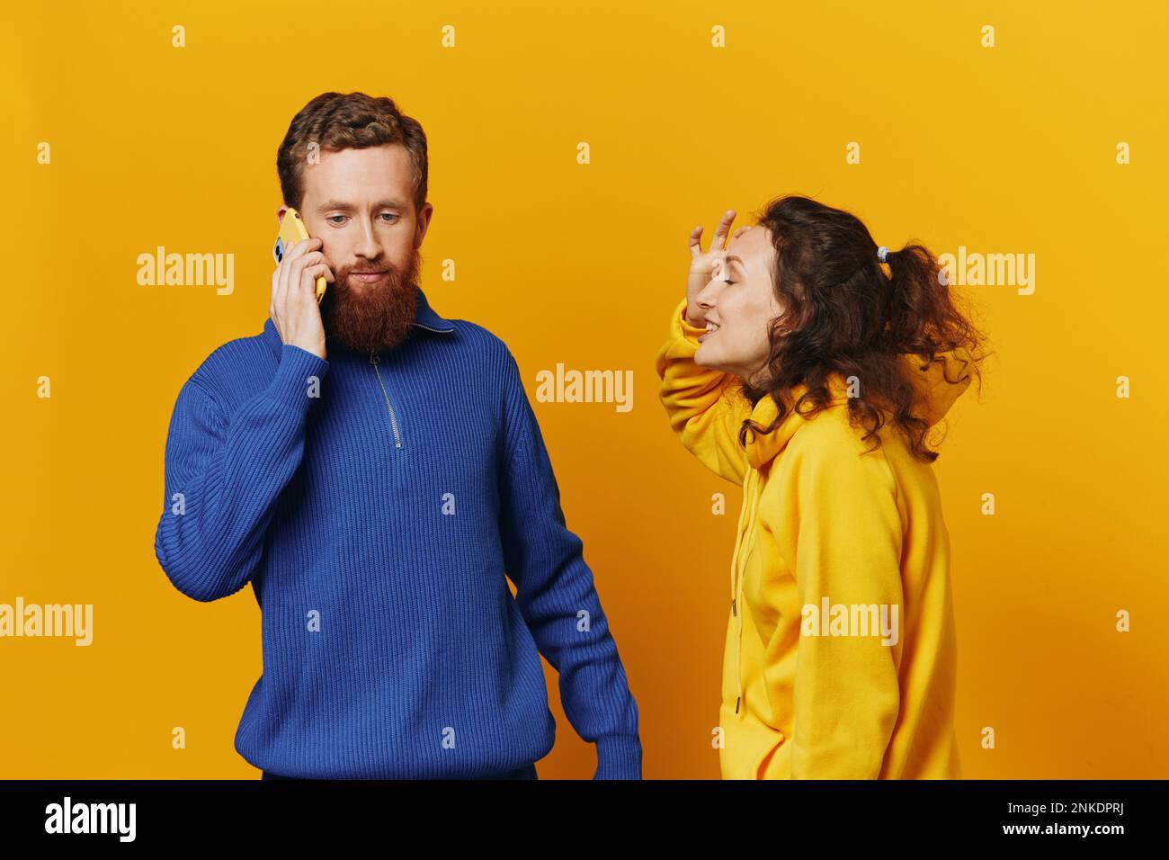 Man and woman couple with phone in hand call talking on the phone, on a ...