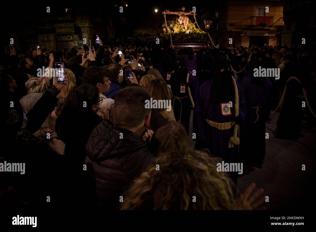 Attendees watch the passage of the Stations of the Cross of Christ of ...