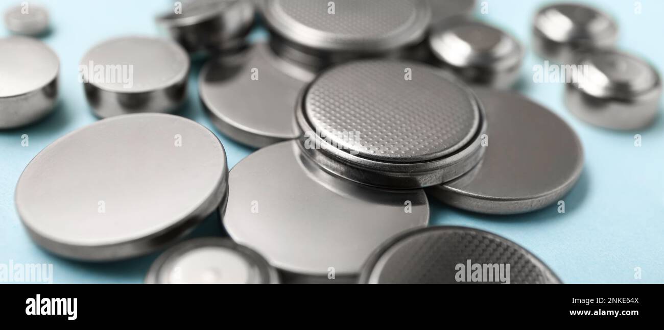 Lithium cell batteries on light blue background, closeup Stock Photo ...