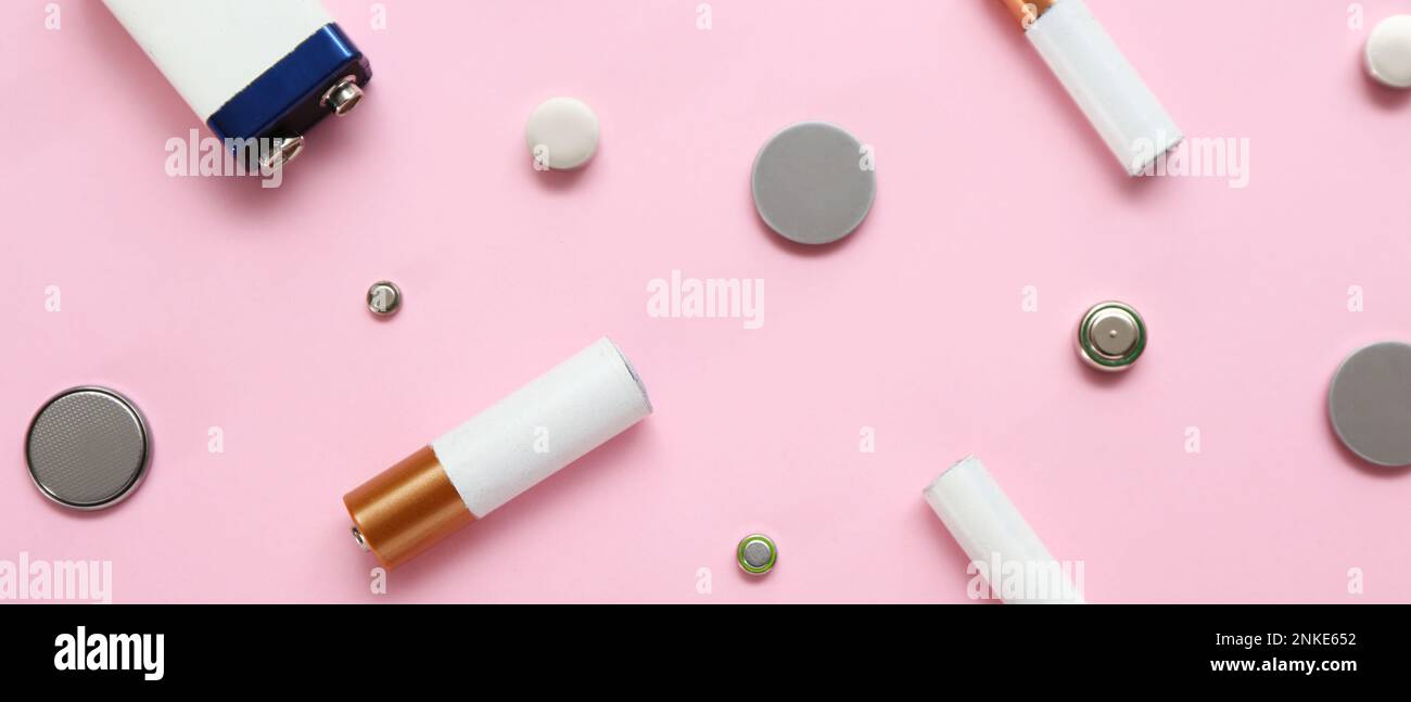 Different batteries on pink background, top view Stock Photo - Alamy