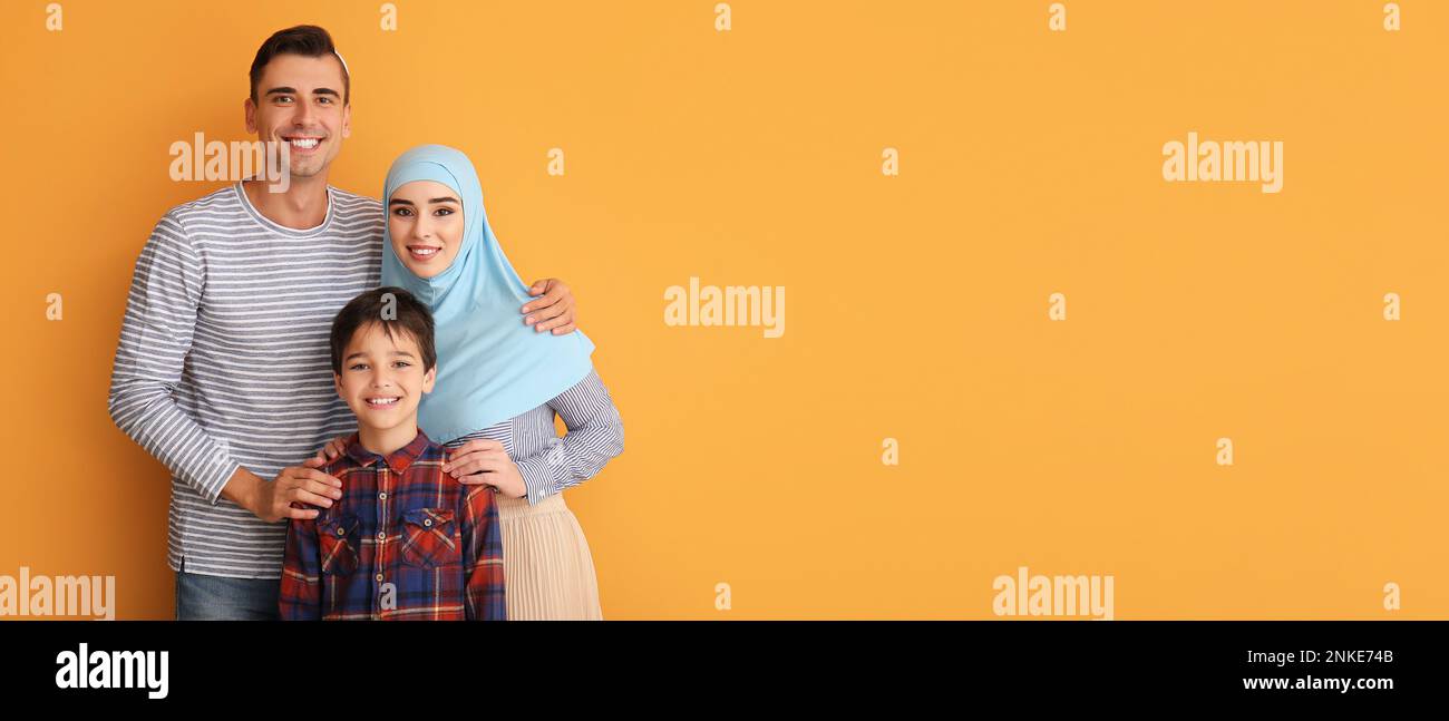 Portrait of Muslim family on orange background with space for text ...