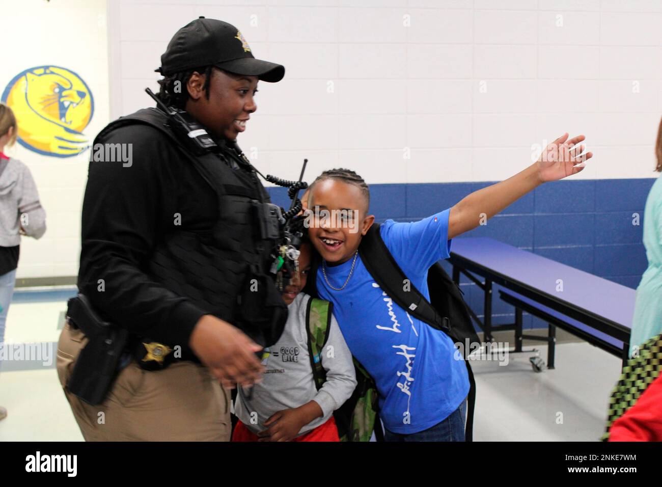 A line of students forms to give a hug to school resource officer Bea ...