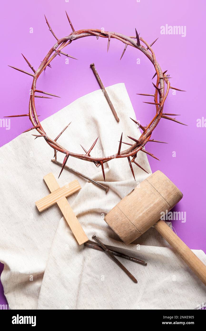 Crown of thorns with cross, nails, mallet and shroud on lilac ...