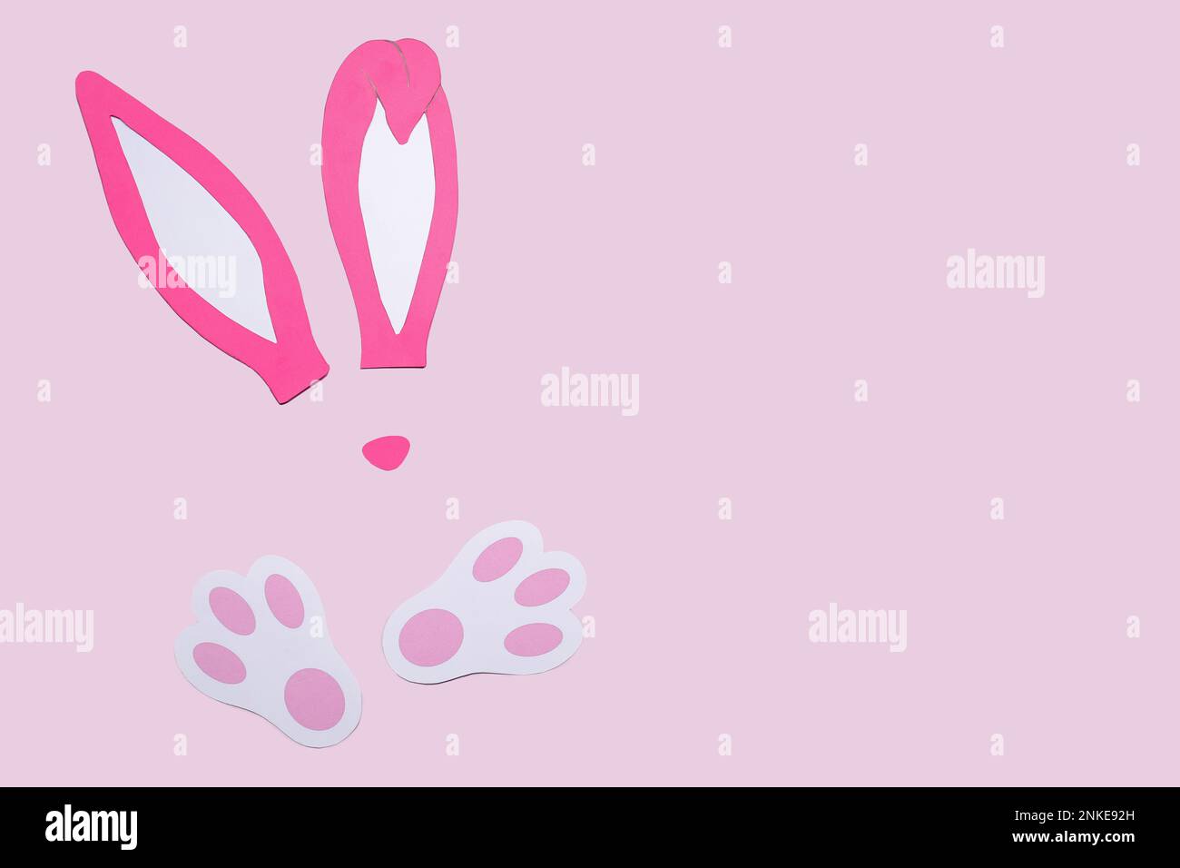 Paper bunny ears, nose and paws on color background Stock Photo - Alamy