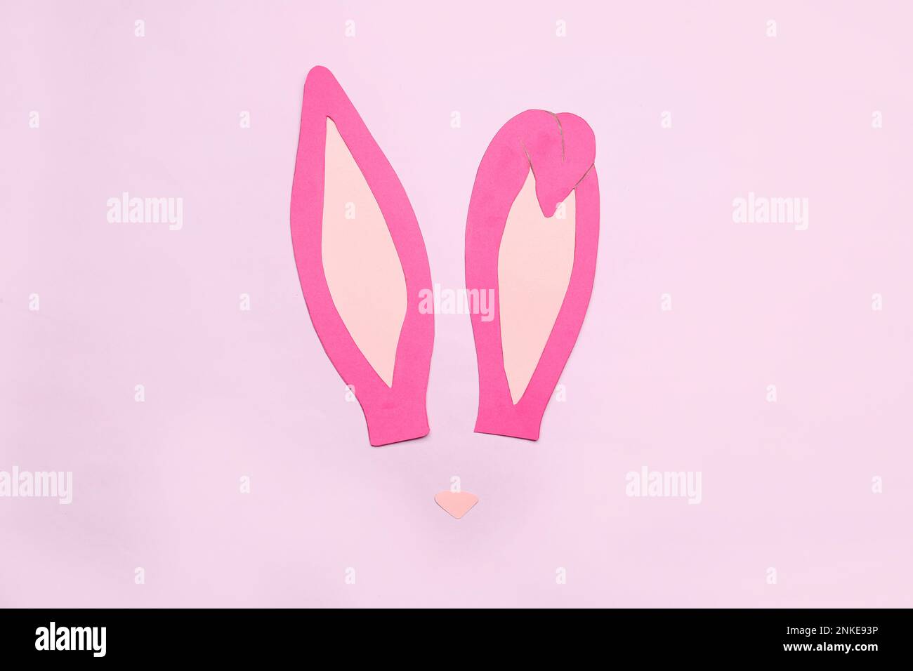 Paper bunny ears and nose on color background Stock Photo - Alamy