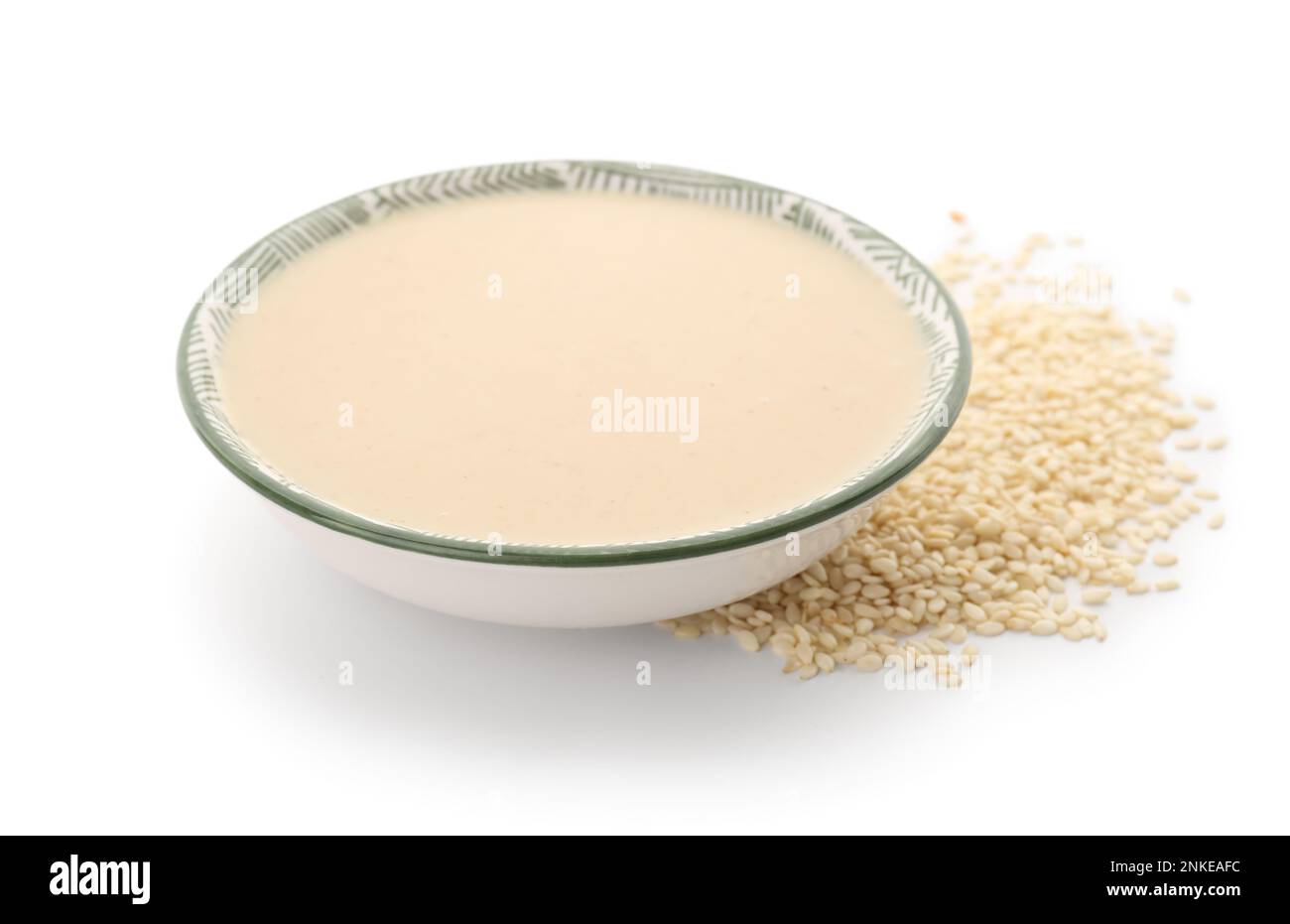 Bowl of tasty tahini isolated on white background Stock Photo - Alamy