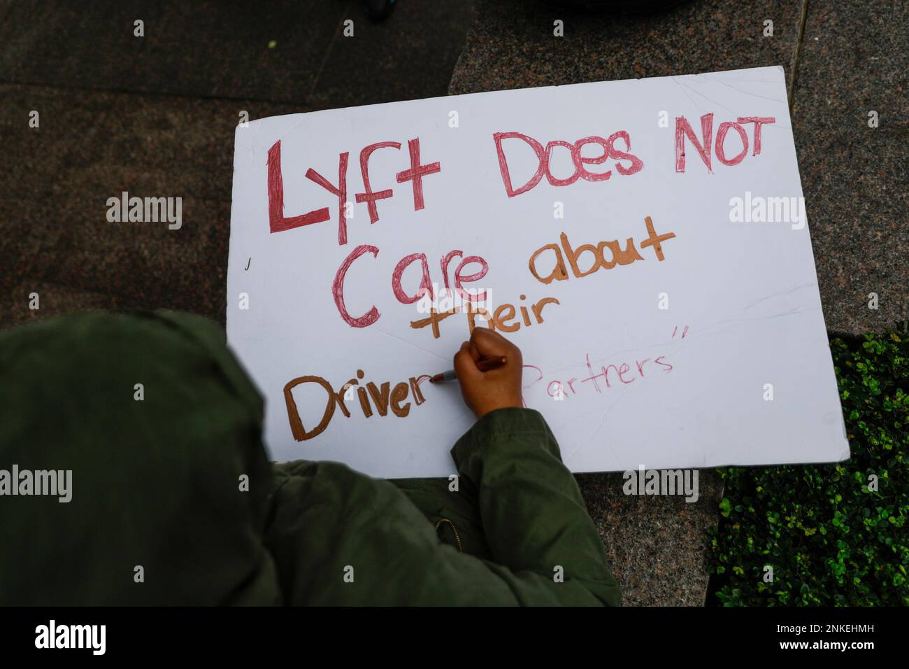 Nia Tulau, 13, draws a poster in support of his family who are ...