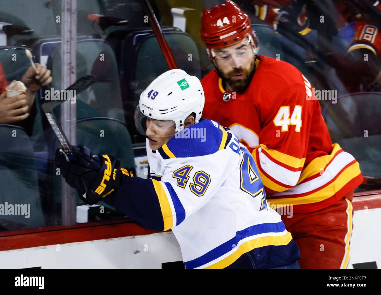St. Louis Blues' Ivan Barbashev, left, checks Calgary Flames' Erik ...