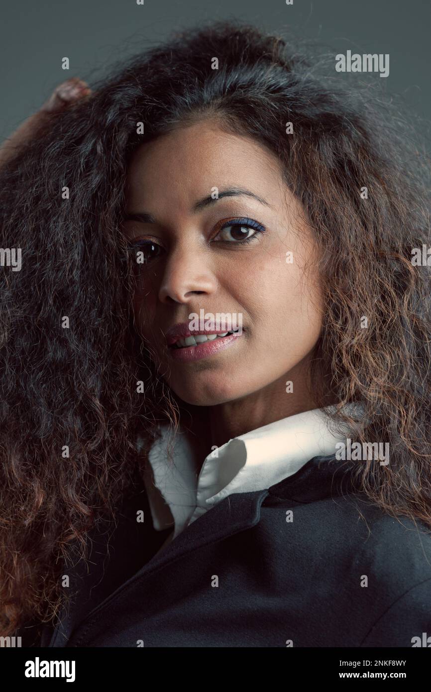 Portrait of Black-skinned Woman and long wavy hair, in elegant white ...