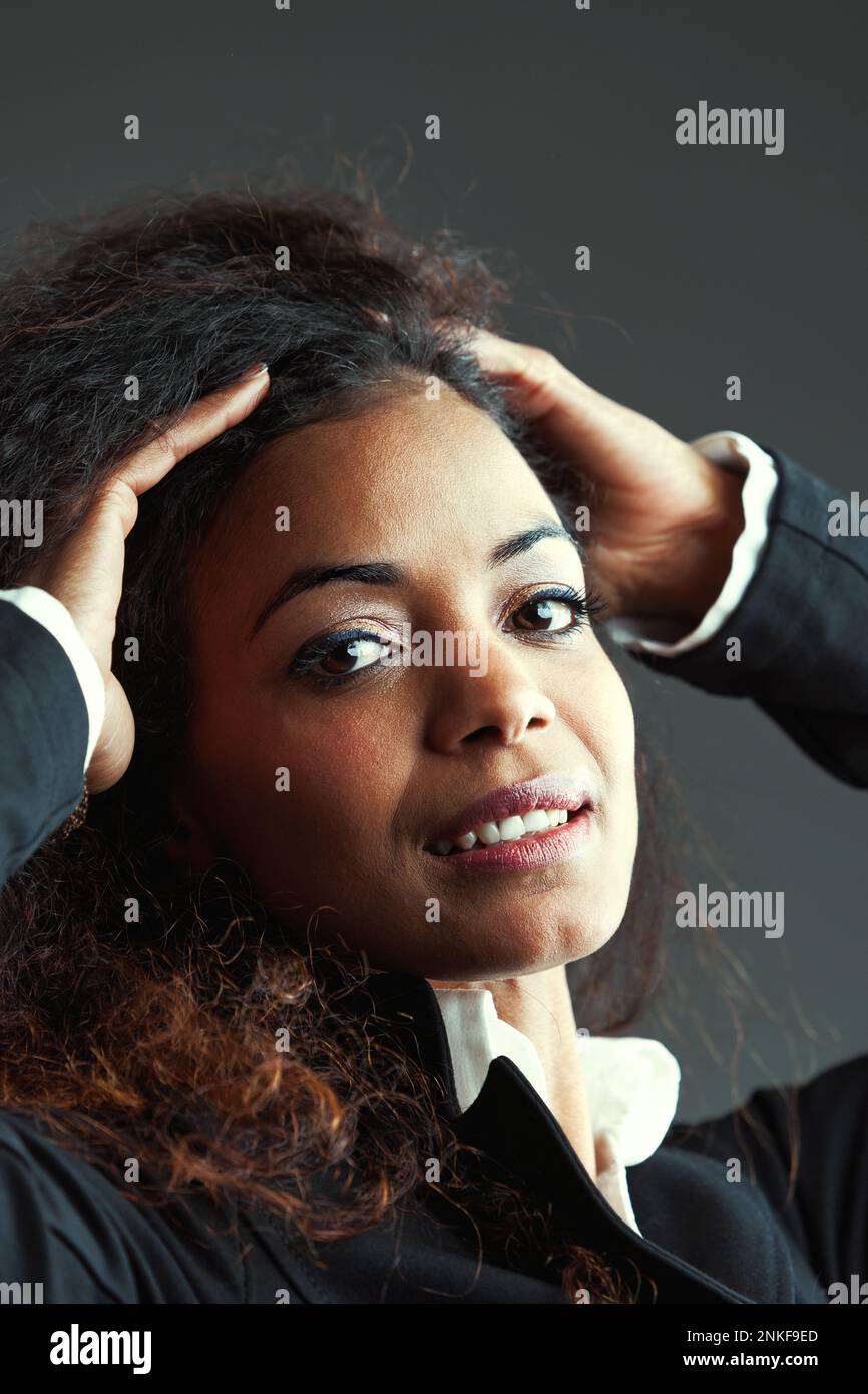 Portrait of Black-skinned Woman with long wavy hair, in elegant white ...