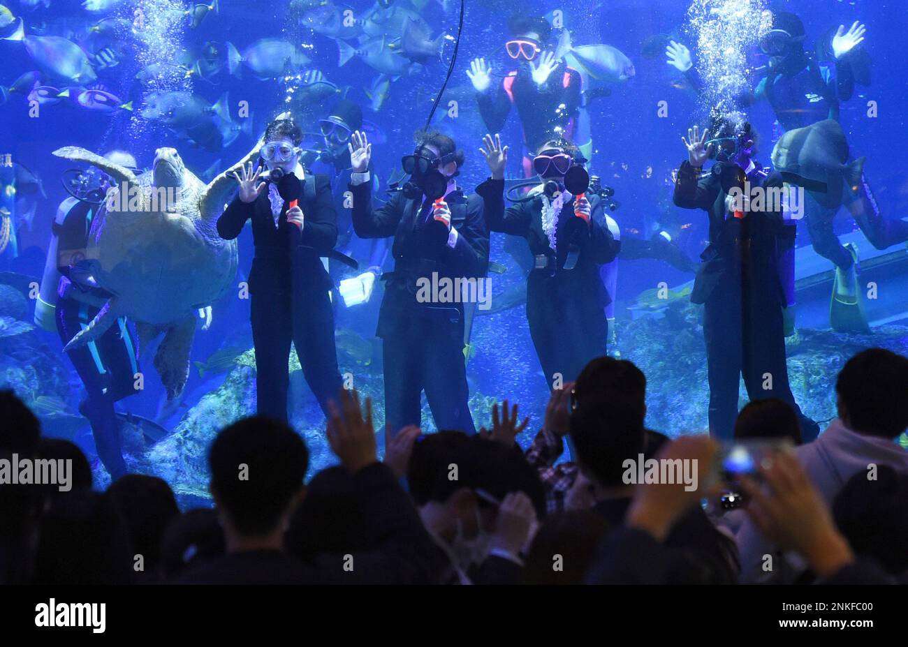 An initiation ceremony for new employees is held in a water tank at the ...