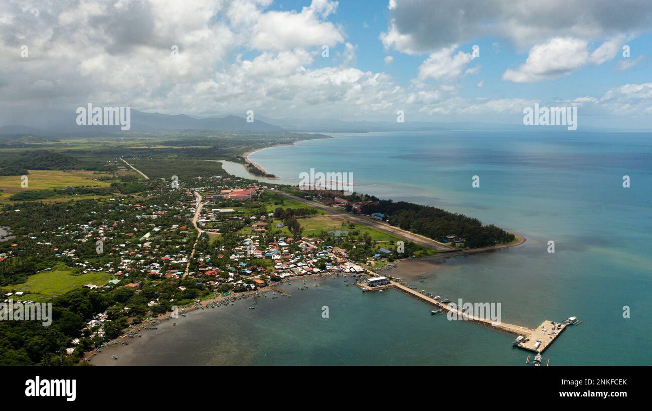 A town on the seashore with a port and a pier. Luzon, Santa Ana ...