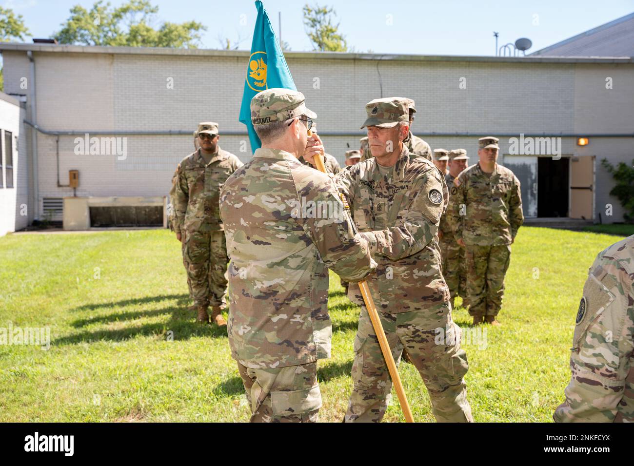 U.S. Army Sgt. Maj. Thomas receives the guidon from Lt. Col. John ...