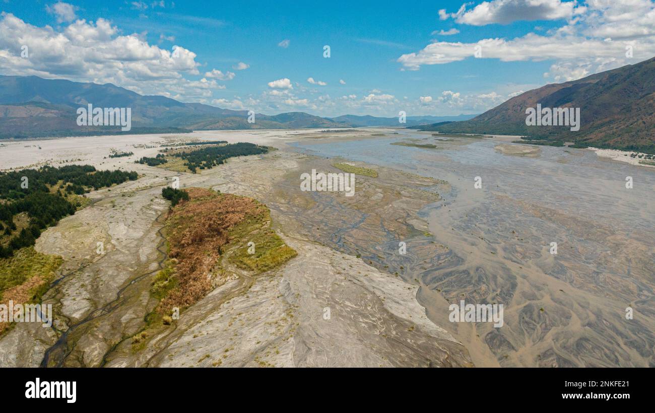 A shallow river bed in a mountain valley. Bucao river. Luzon ...