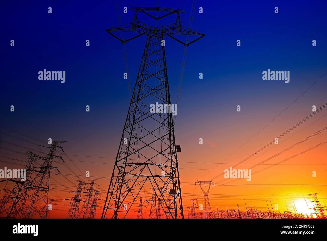 Sunset silhouette of pylon Stock Photo - Alamy
