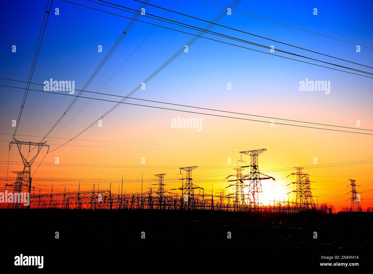 Sunset silhouette of pylon Stock Photo - Alamy