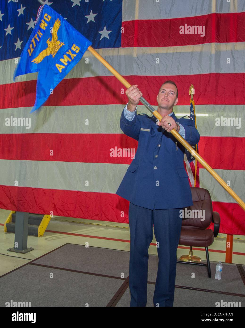 U.S. Air Force Maj. Christopher Manley presents the guidon of the 127th ...