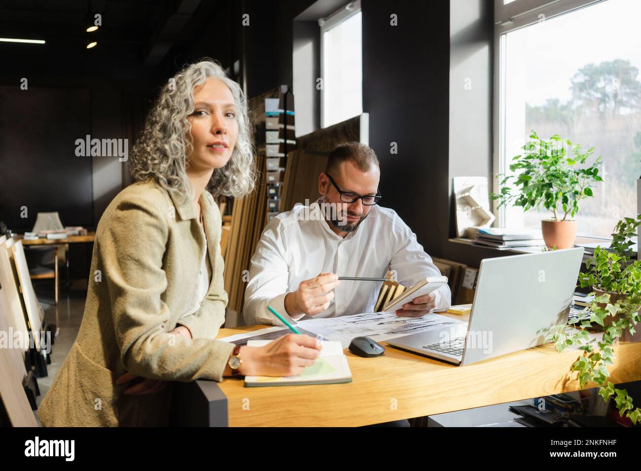 Two colleagues working at table in architect's office Stock Photo - Alamy