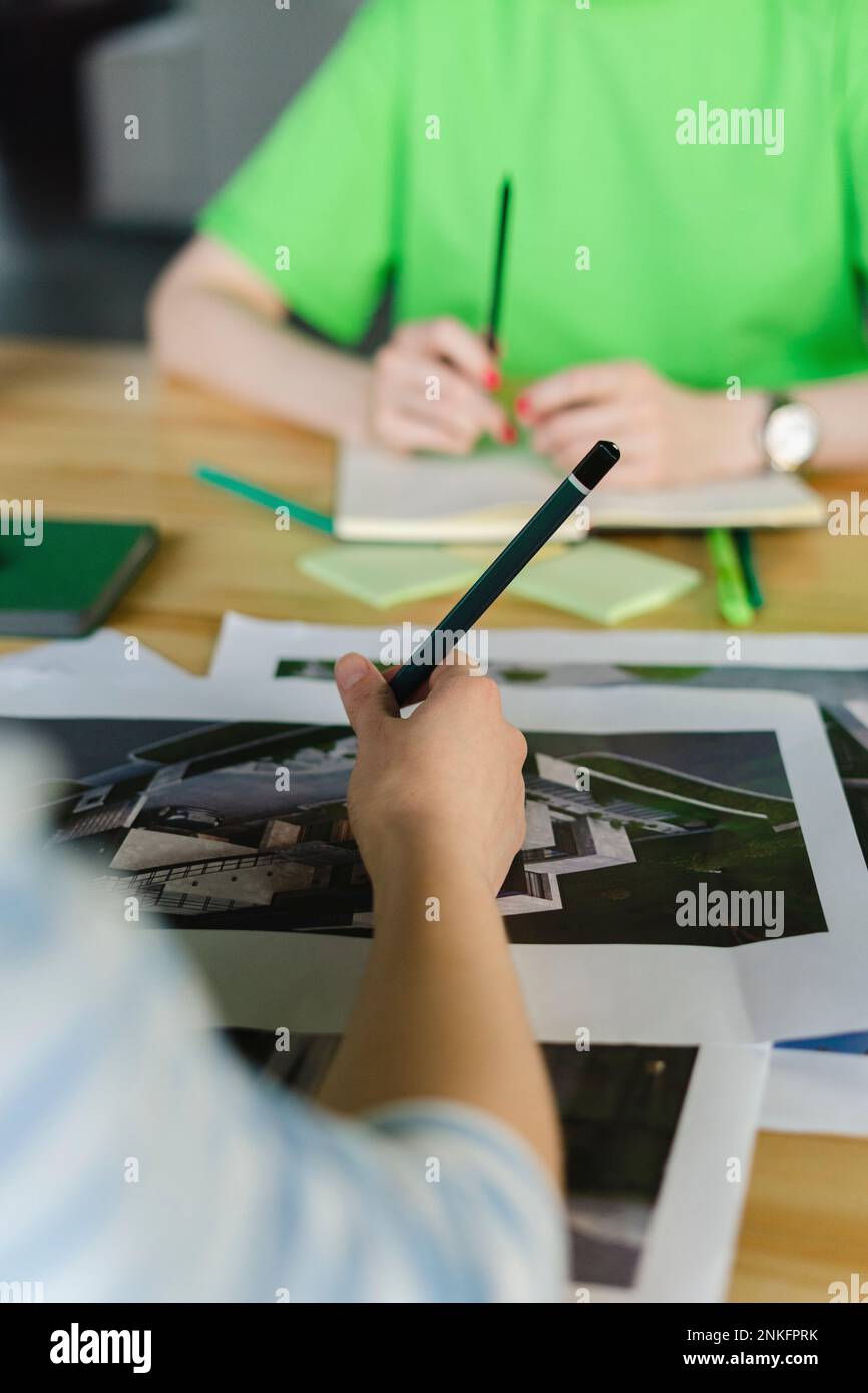 Two women working on house plan Stock Photo - Alamy