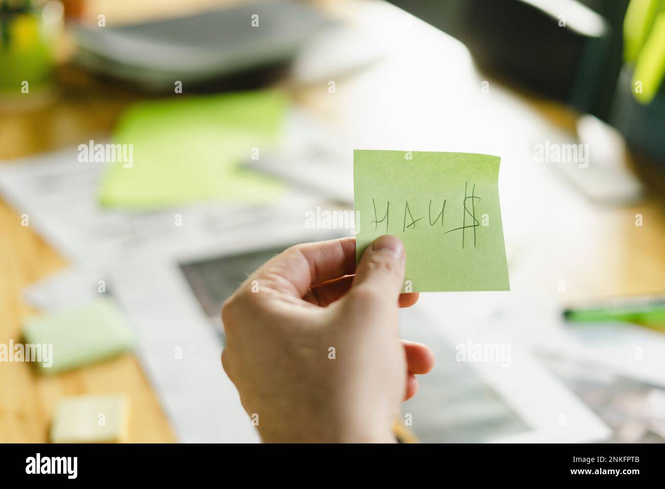 Hand holding slip of paper in conference room Stock Photo - Alamy