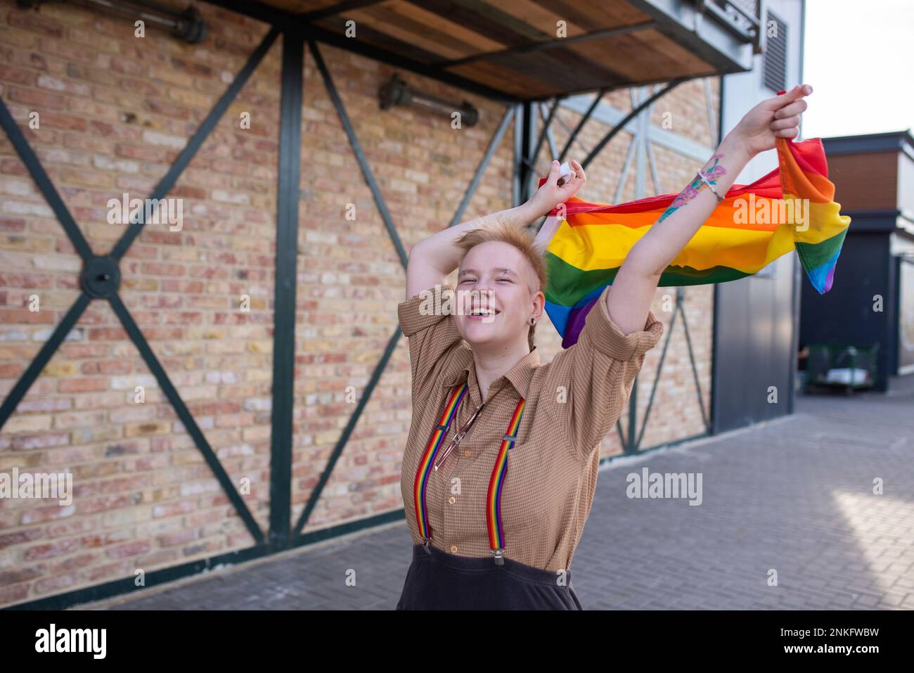 Carefree non-binary person holding LGBTQIA pride flag on street Stock ... Carefree non-binary person holding LGBTQIA pride flag on street Stock ...