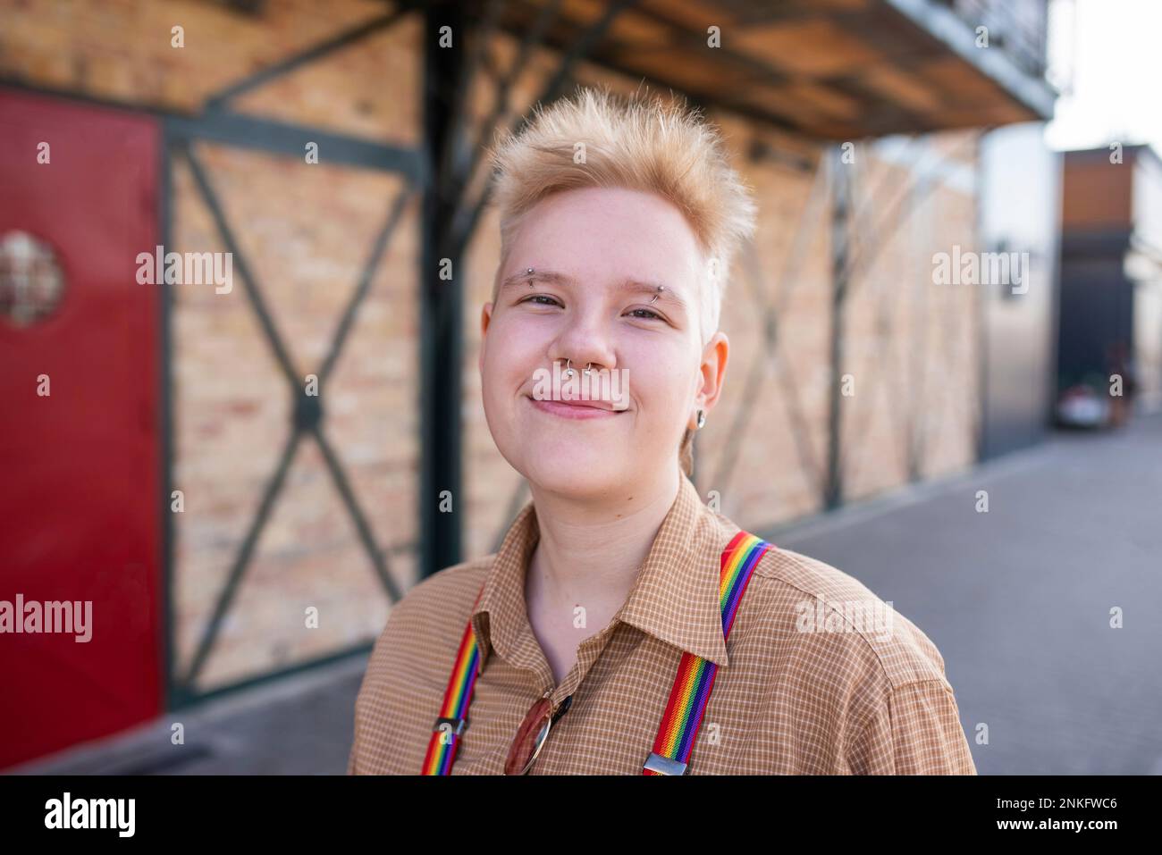 Smiling non-binary person wearing nose ring on street Stock Photo - Alamy