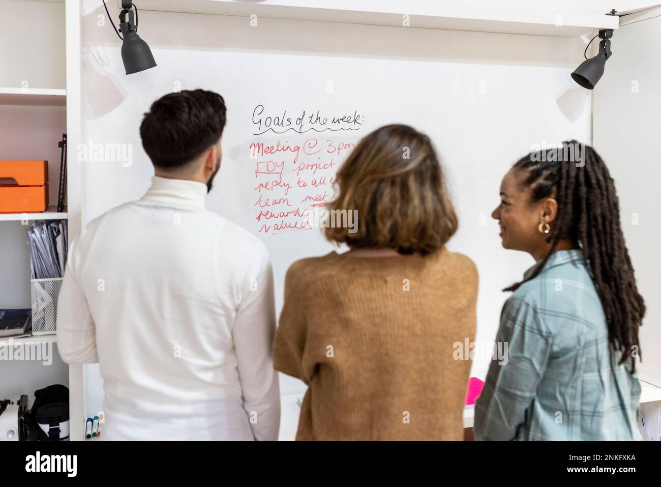 Business people looking at visual board in office Stock Photo - Alamy