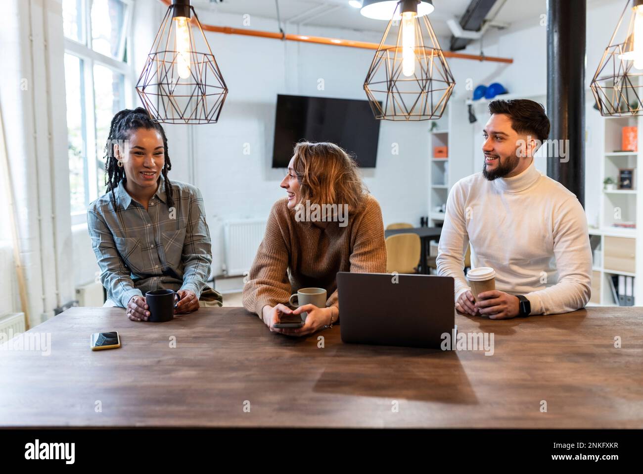 Happy colleagues having coffee hi-res stock photography and images - Alamy